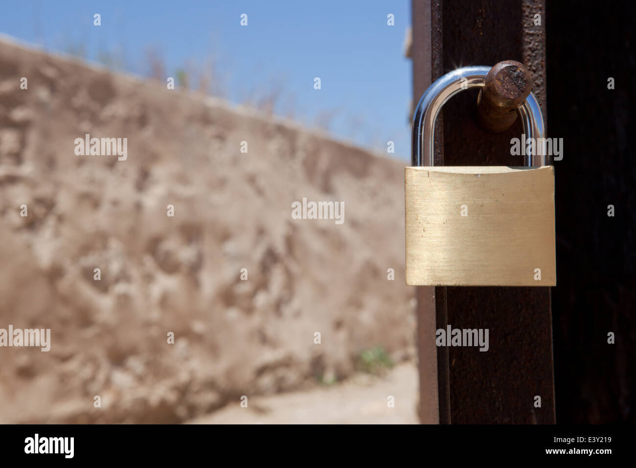 New pad lock hanging on a rusty metal frame. Country house place Stock ...