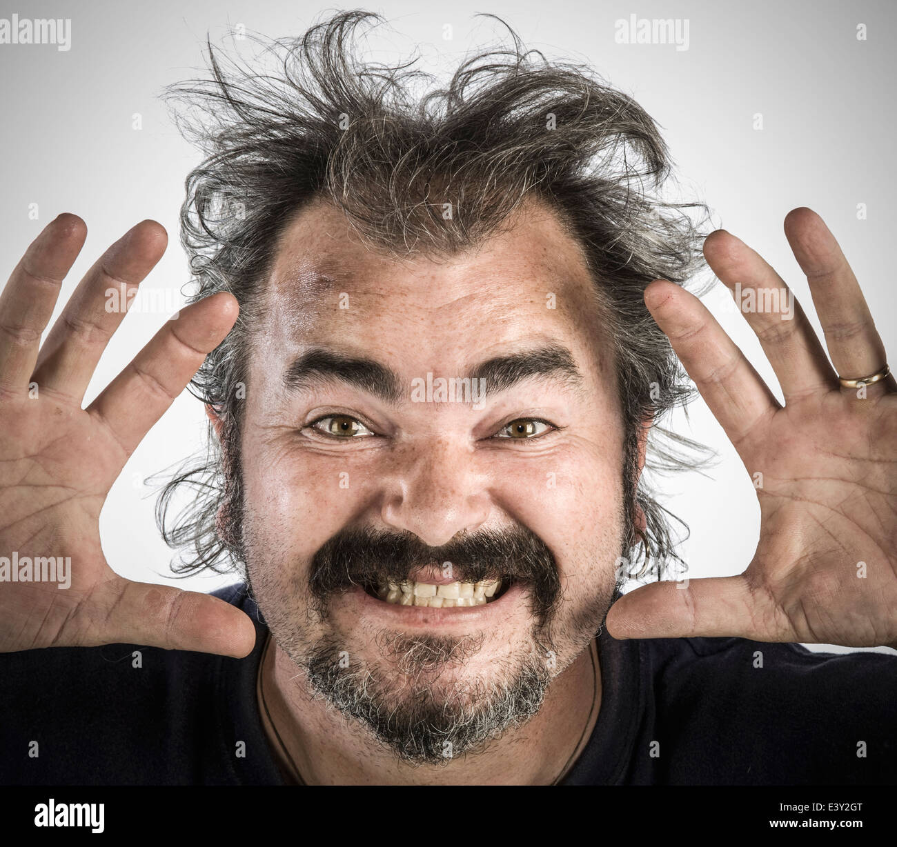 Man with messy hair making face Stock Photo - Alamy