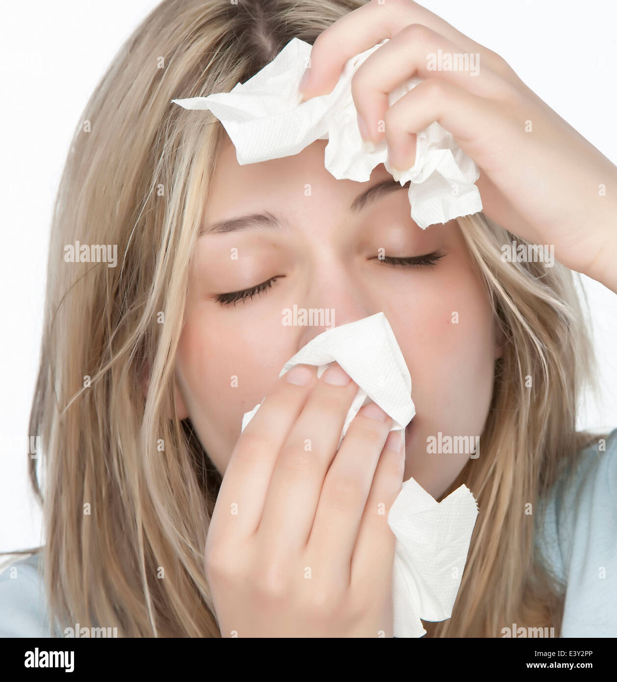 Woman wiping her nose with tissue Stock Photo - Alamy