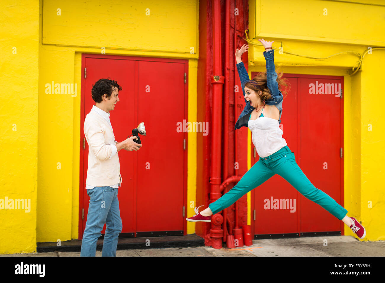 Couple having fun whilst taking photograph Stock Photo - Alamy