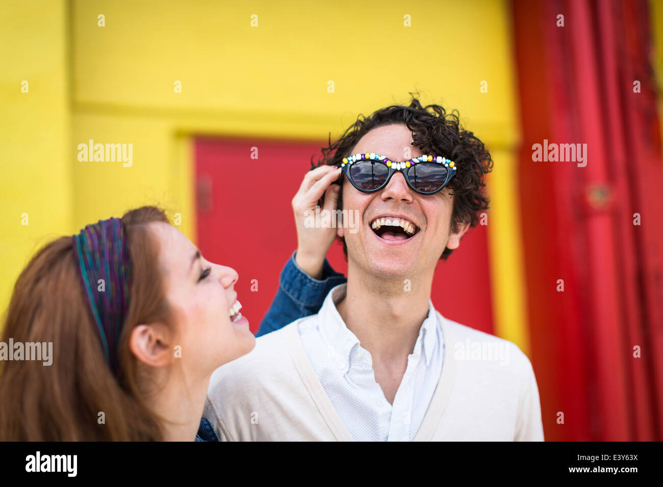 Couple trying on fun sunglasses Stock Photo - Alamy