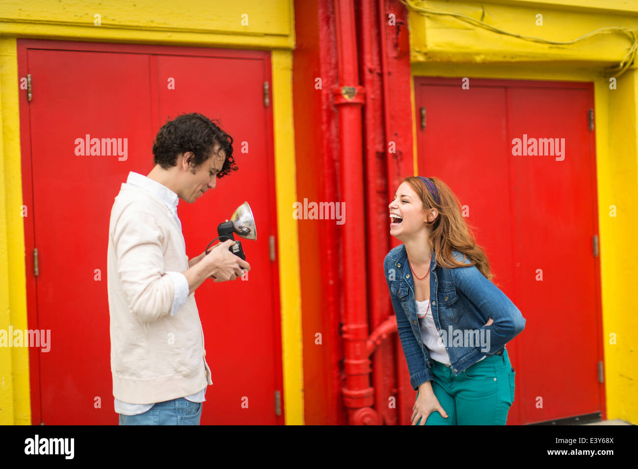 Couple having a laugh whilst taking photograph Stock Photo - Alamy
