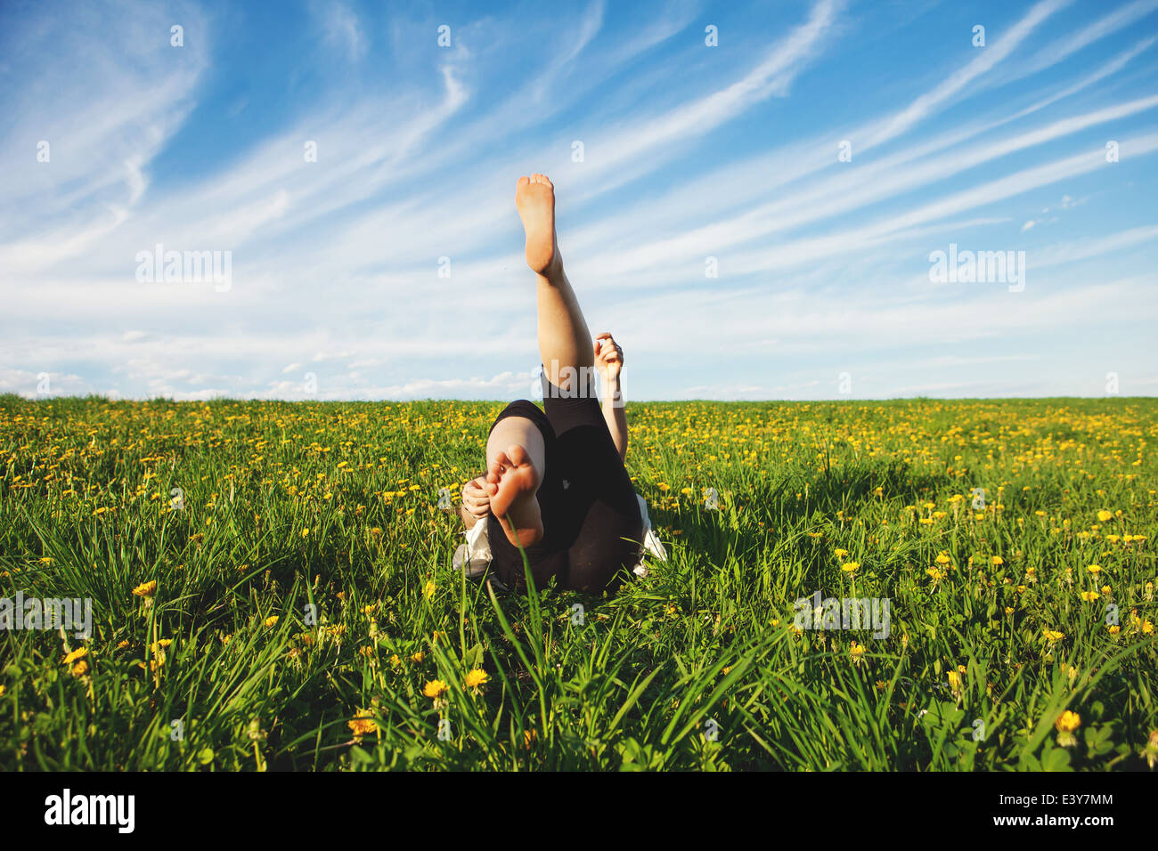 Woman lying on back legs up hi-res stock photography and images - Alamy