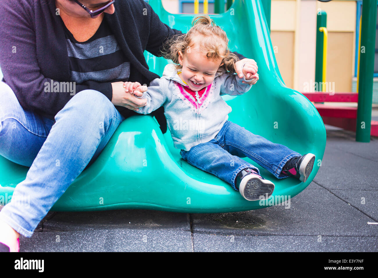 Mother daughter going down slide hi-res stock photography and images ...