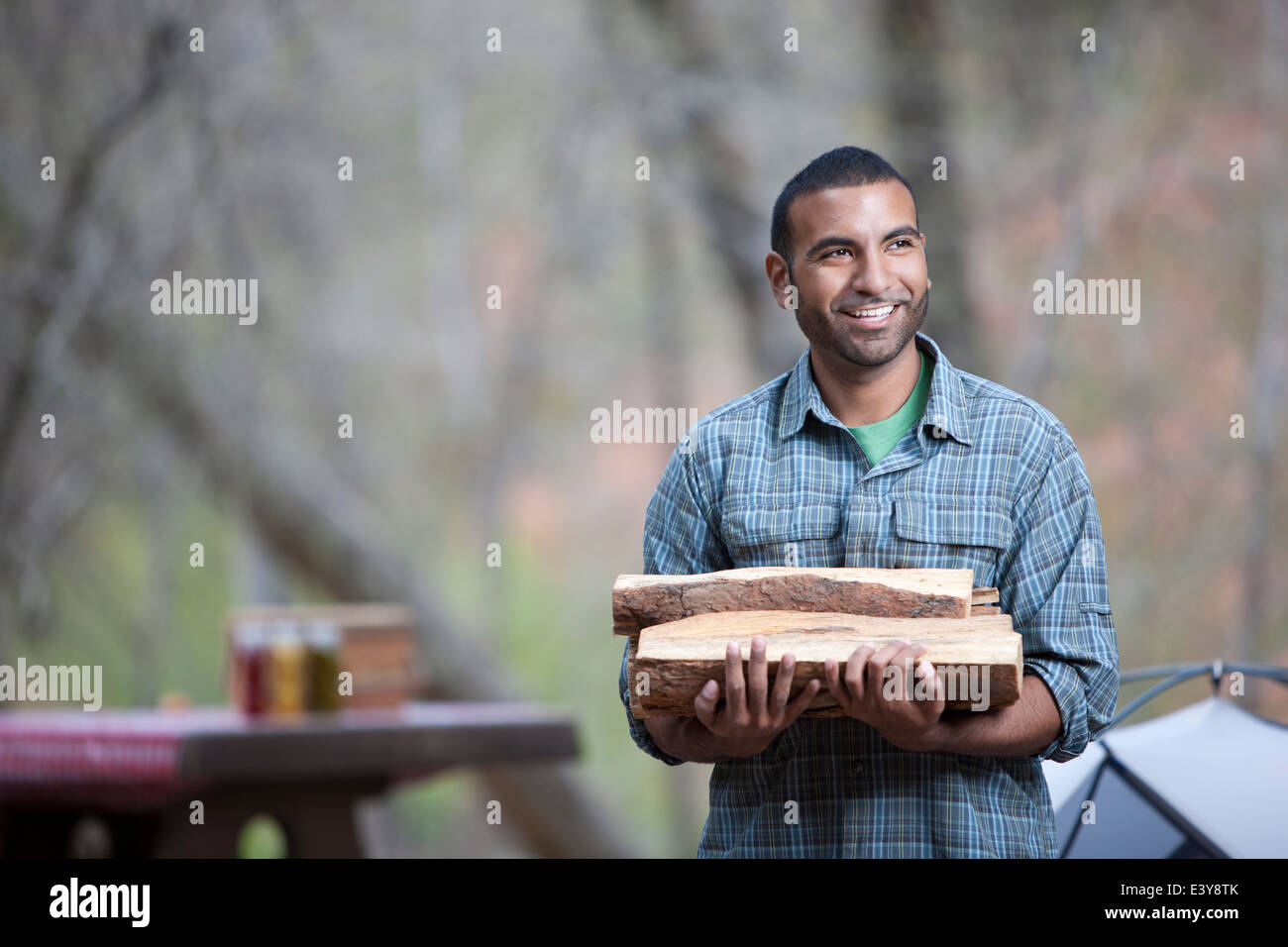 Young man carrying logs on campsite, Sedona, Arizona, USA Stock Photo ...