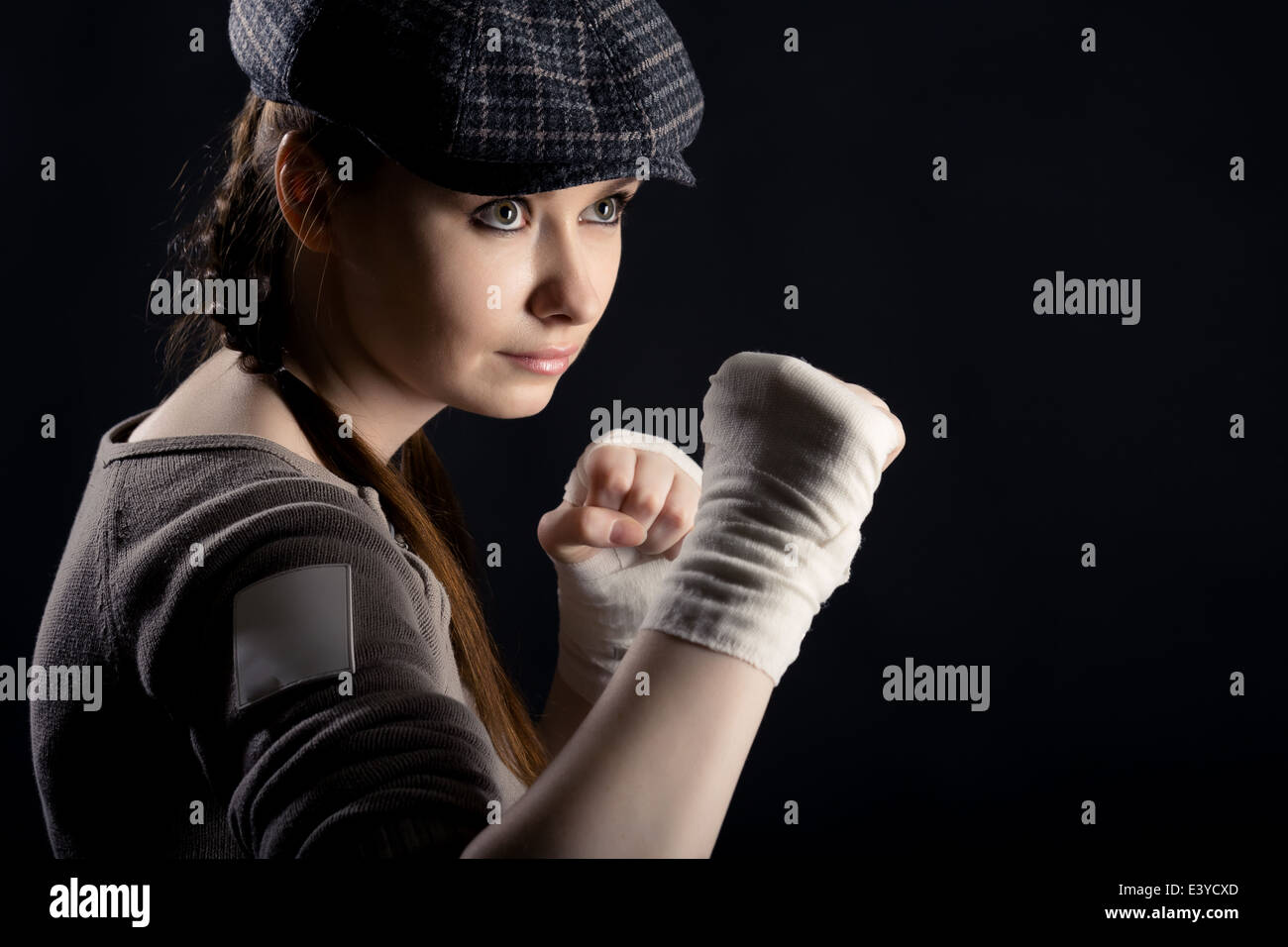 On a black background girl with a fighting stance Stock Photo - Alamy
