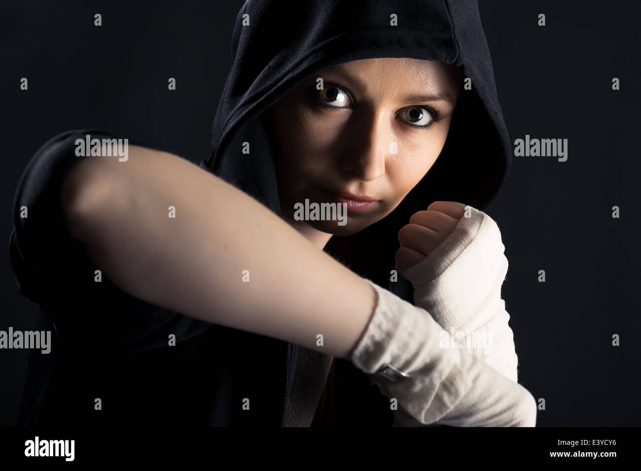 On a black background girl with a fighting stance Stock Photo - Alamy