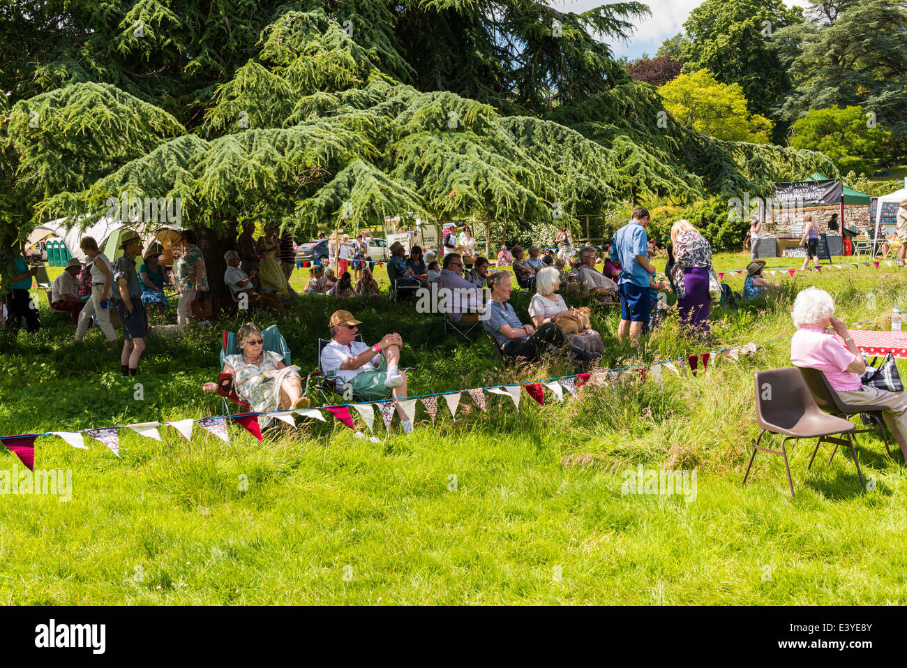East Devon, England. A Fete and garden party with people sitting in the ...