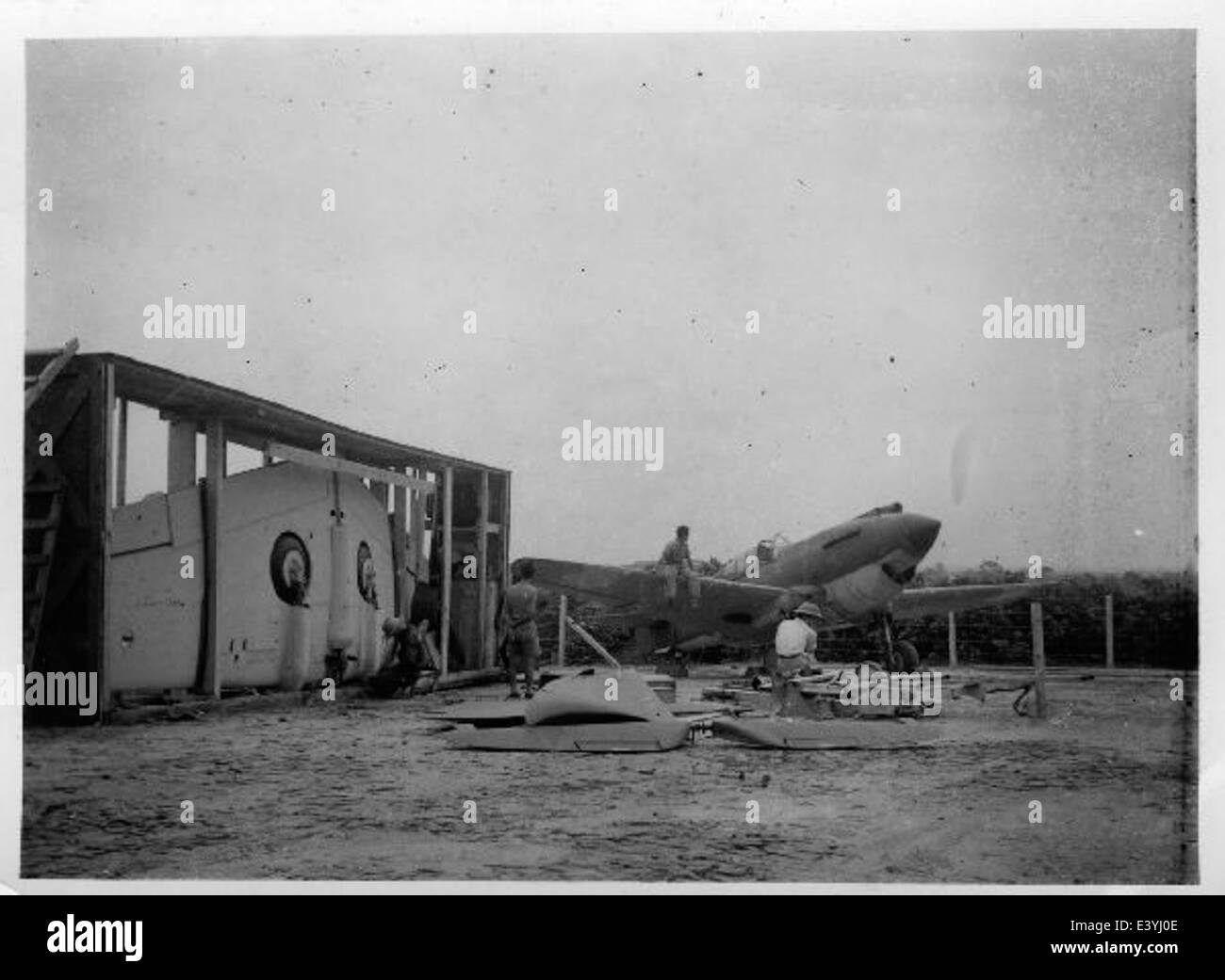 This photograph shows the assembly process of a P-40 aircraft ...