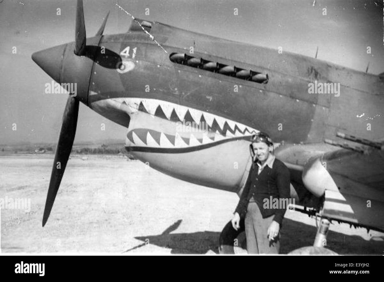 A photograph of Walter Pentecost with a P-40 aircraft at Loiwing, China ...