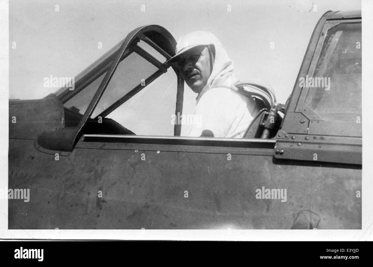 Photograph of a pilot named Glover standing by a P-40 aircraft, with ...