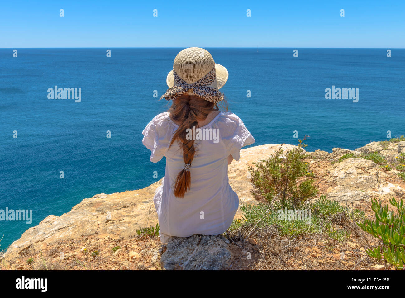 Tourist enjoying the ocean view from a cliff in Algarve, Portugal Stock ...
