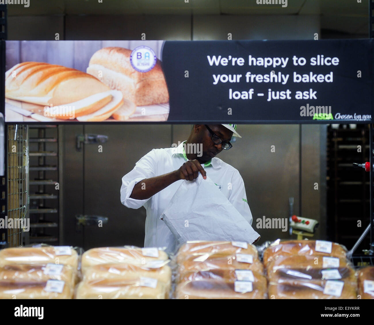 baker in a supermarket behind the bread counter Stock Photo - Alamy