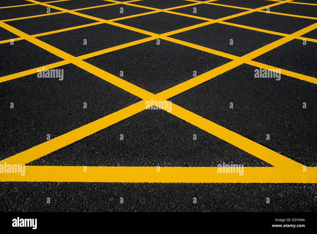 cross yellow lines on blacktop Stock Photo - Alamy