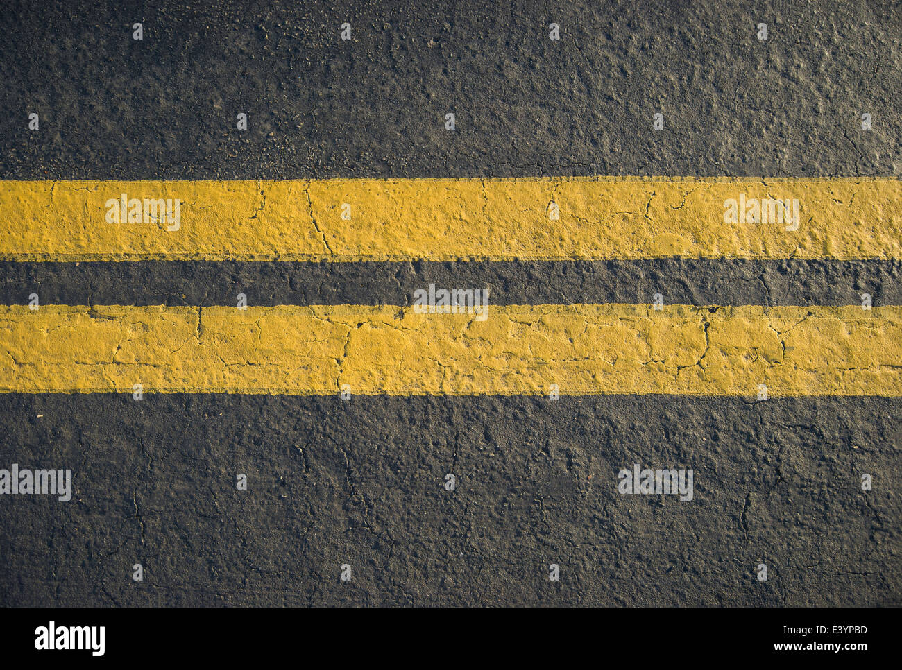 double yellow lines divider on blacktop Stock Photo - Alamy