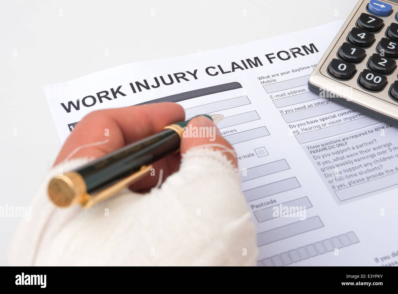 filling up a work injury claim form Stock Photo - Alamy