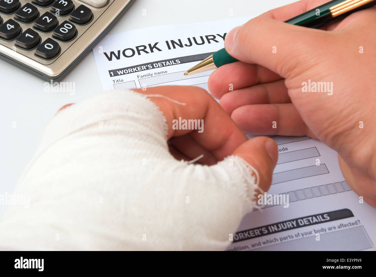filling up a work injury claim form Stock Photo - Alamy
