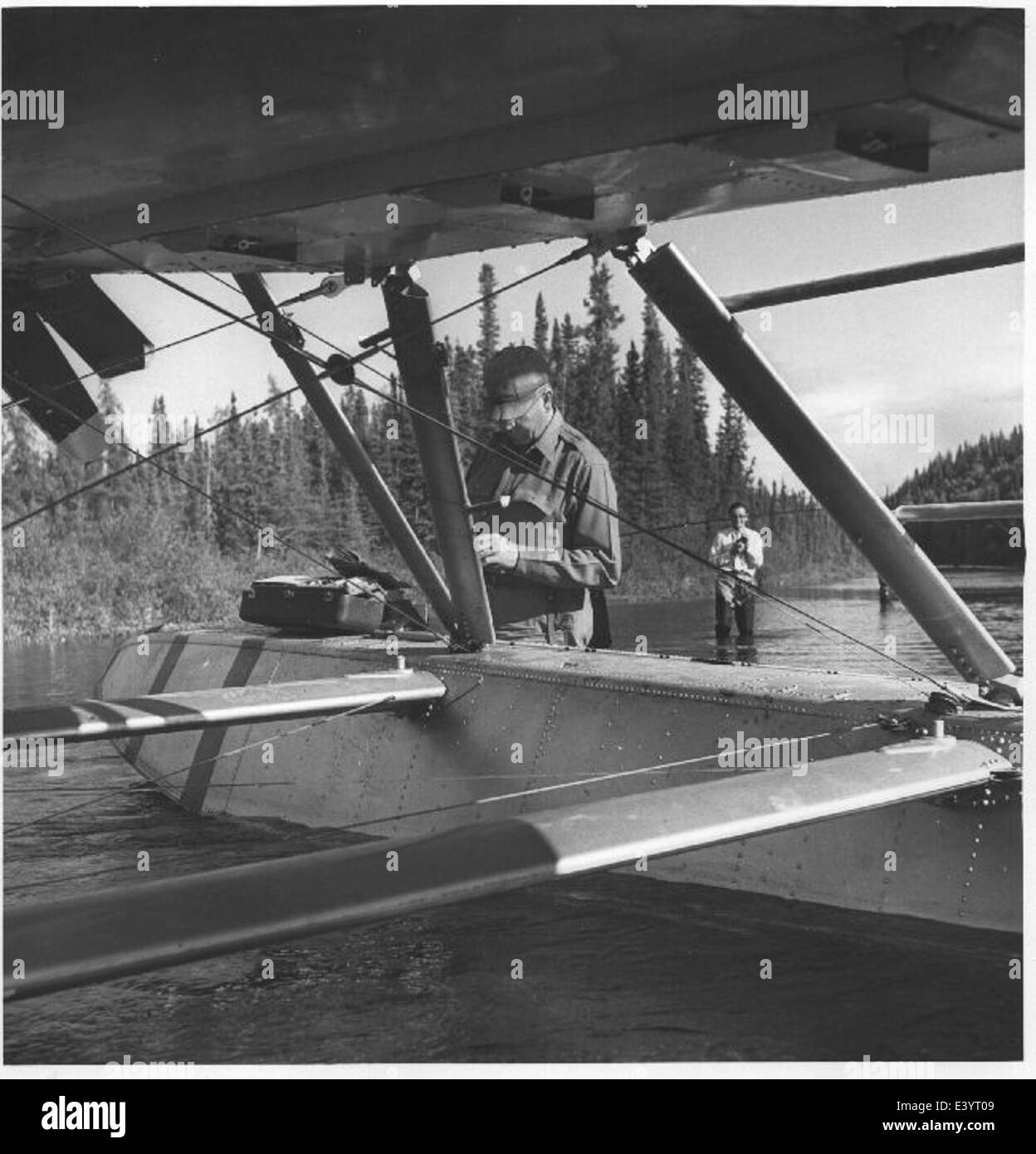 This photograph depicts an aircraft in the process of fishing ...