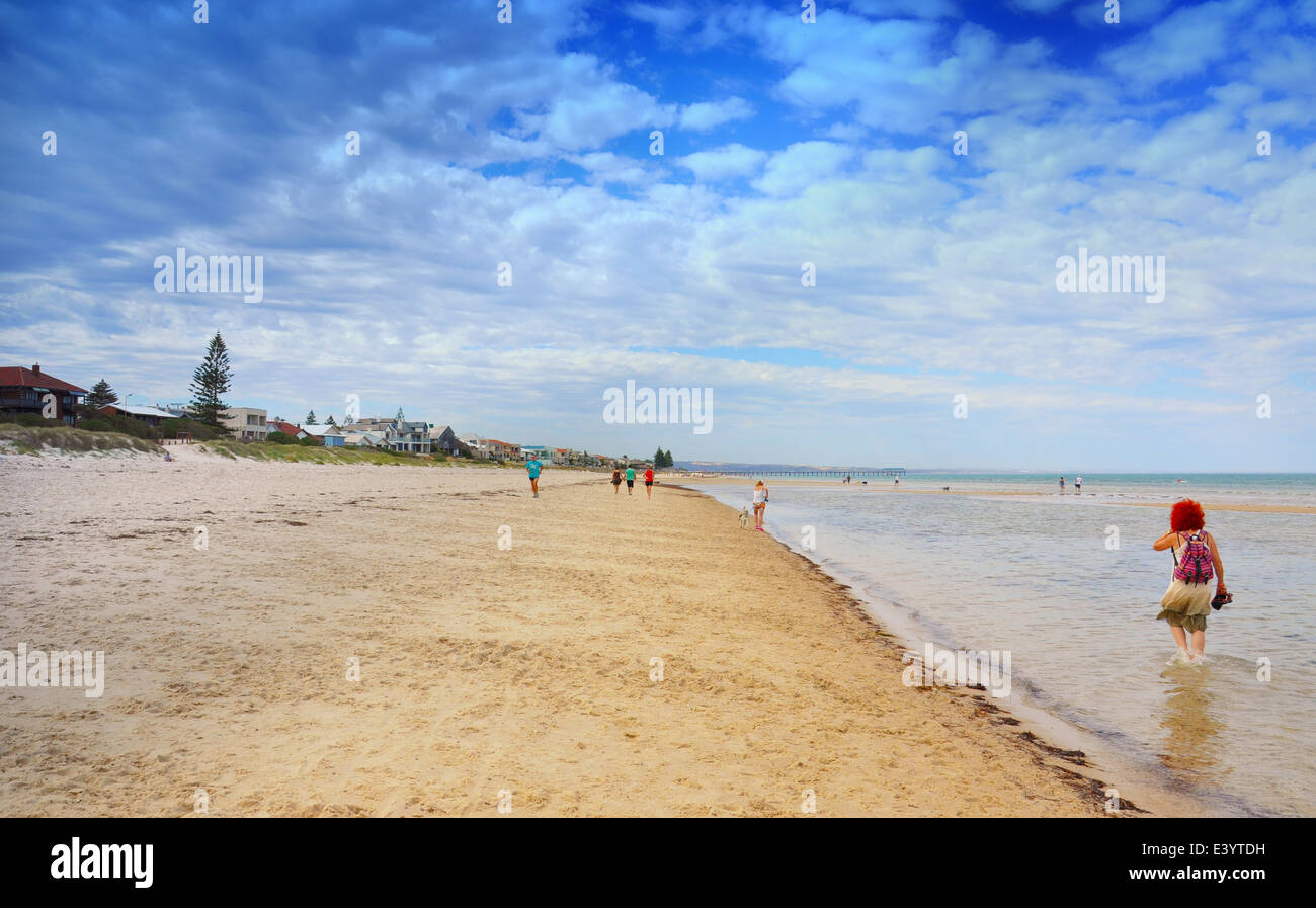 People walking and exercising on beach on cloudy day Stock Photo - Alamy