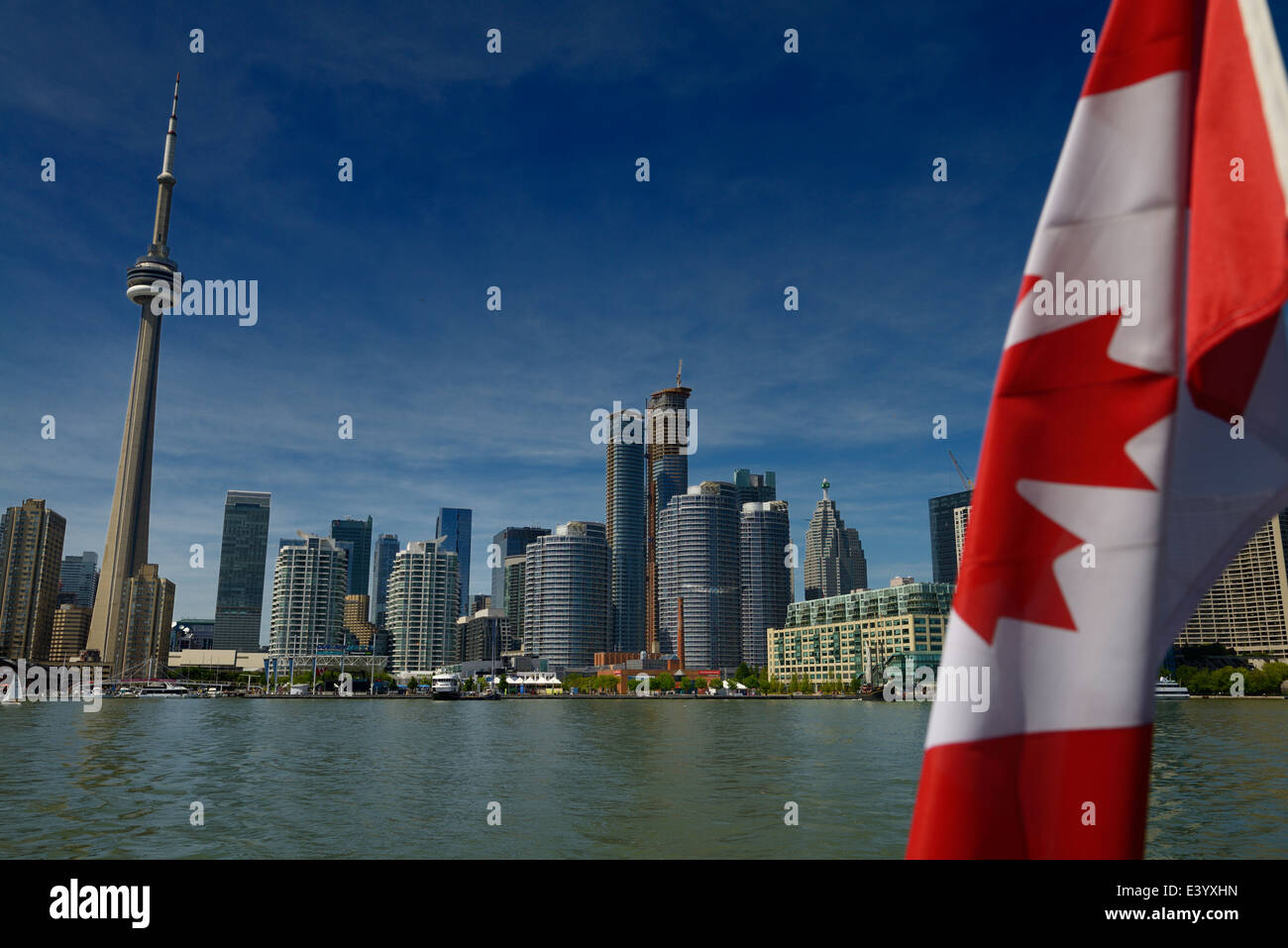 Canadian flag with Toronto skyline and CN Tower at harbourfront on Lake ...