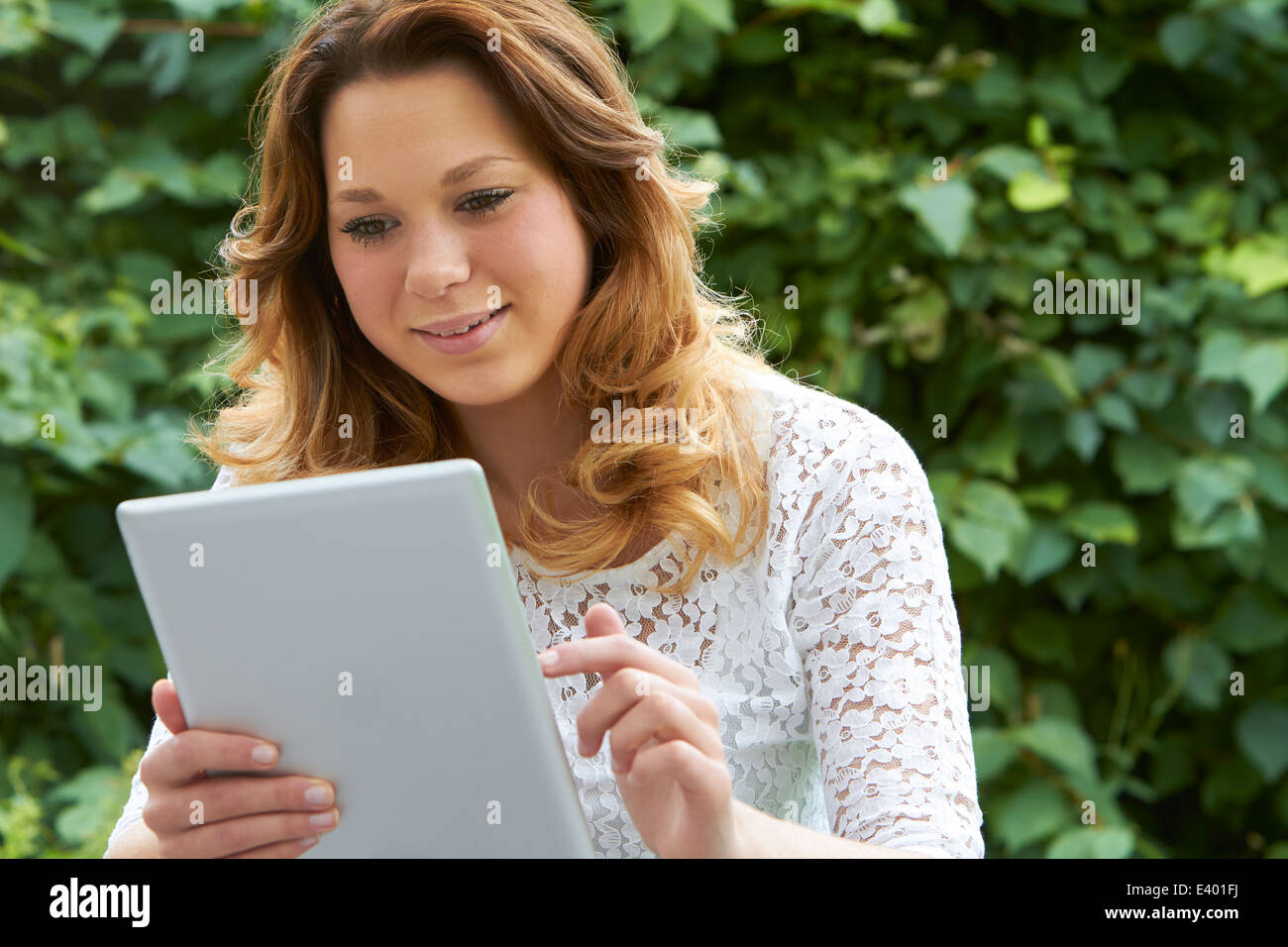 Teen girl reading tablet hi-res stock photography and images - Alamy