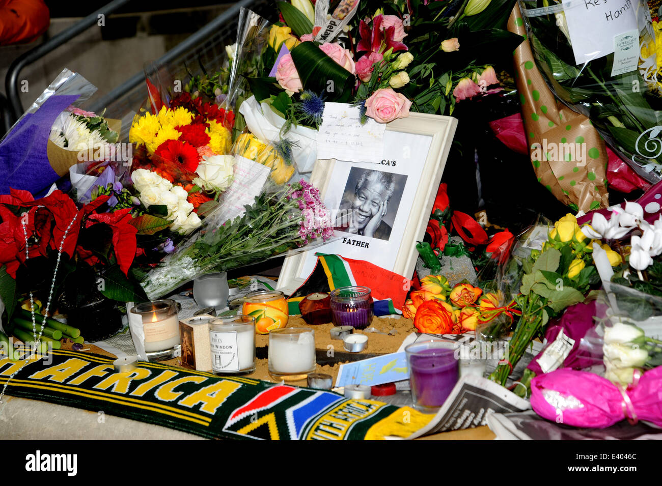 Tributes to Nelson Mandela are laid at his statue in Parliament Square ...