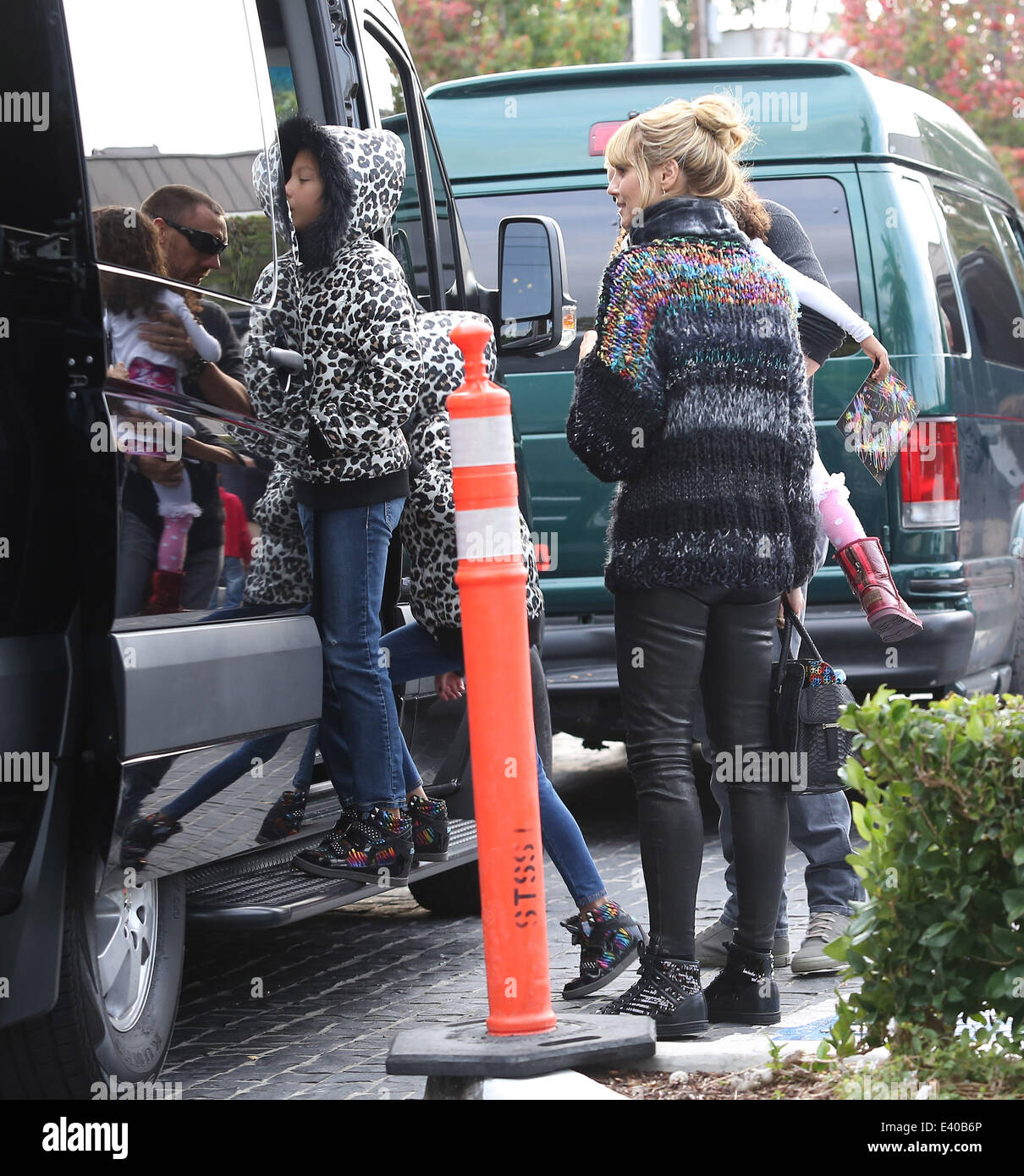 Heidi Klum takes children, wearing matching animal print coats ...