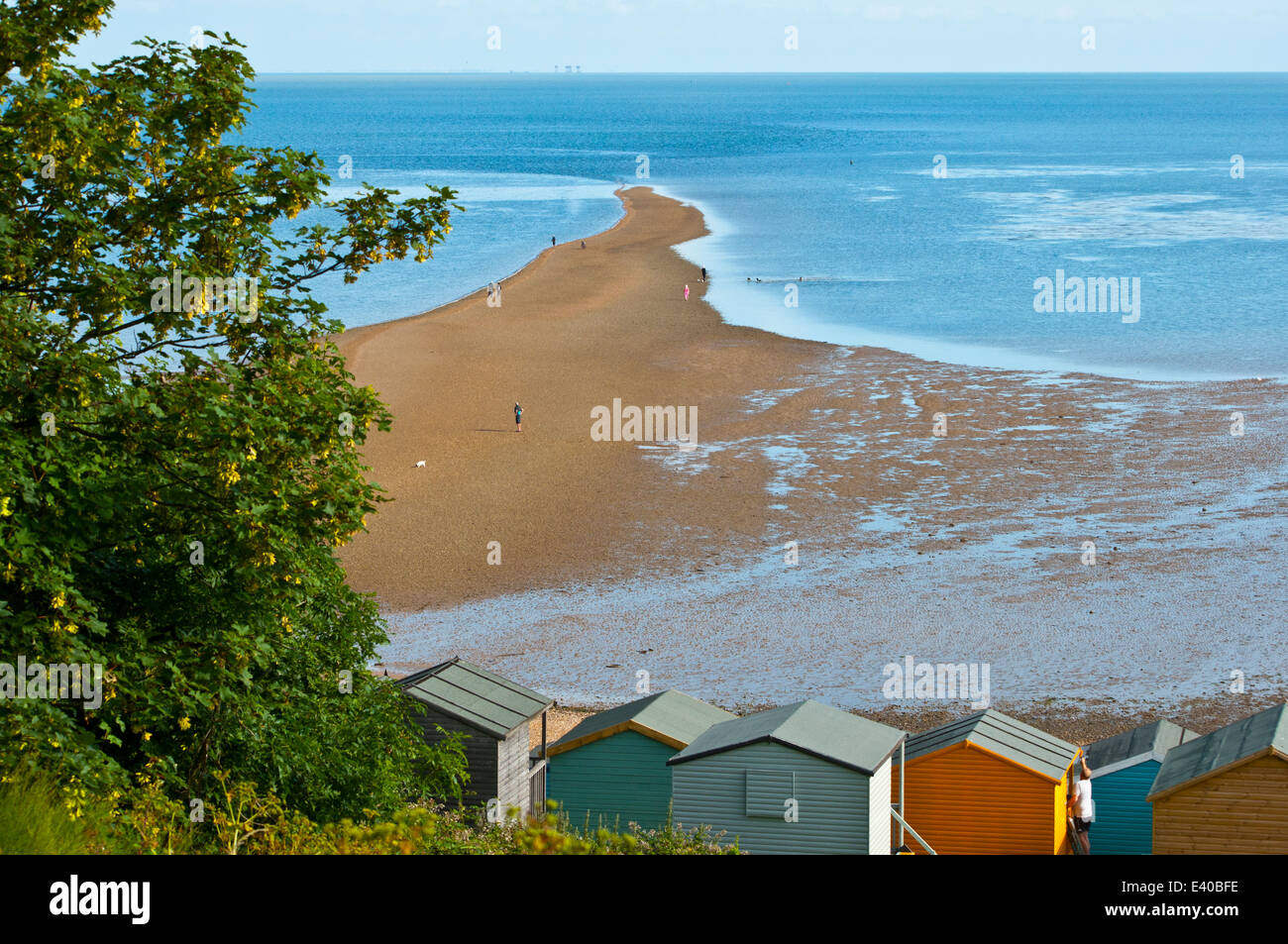 People walking The Street natural strip of shingle bank Tankerton Beach ...