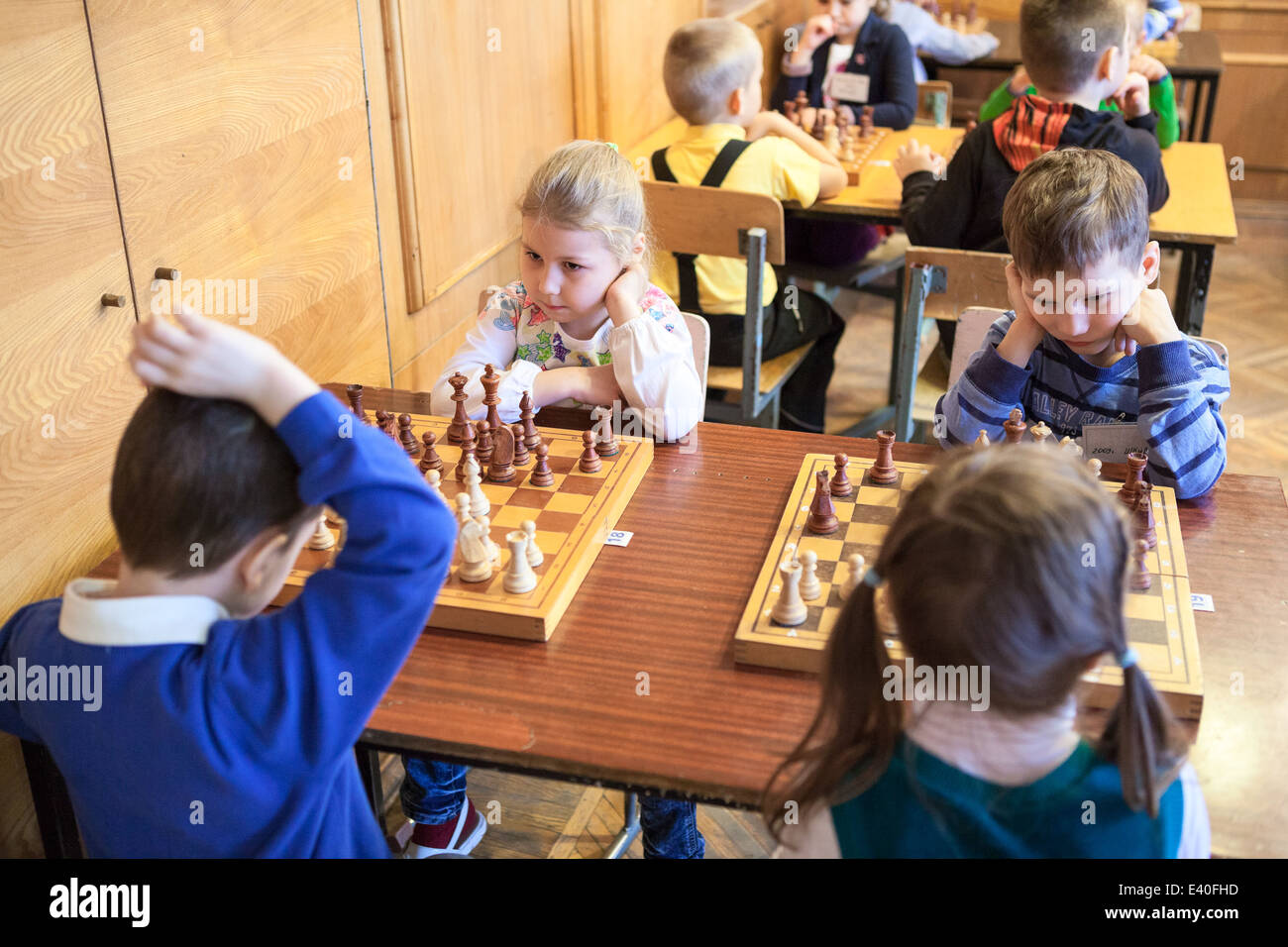 Children are playing a chess game. Regional chess tournament among ...