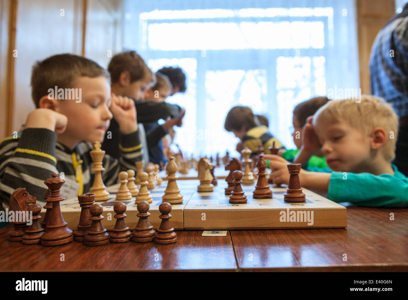 Children are playing a chess game. Regional chess tournament among ...