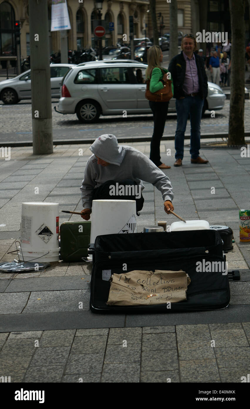 A would-be drummer uses plastic buckets collecting donations on Avenue ...