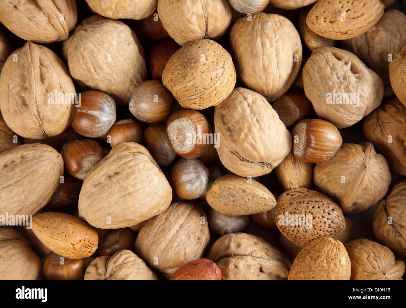 Closeup into a bowl full of autumn nuts Stock Photo - Alamy