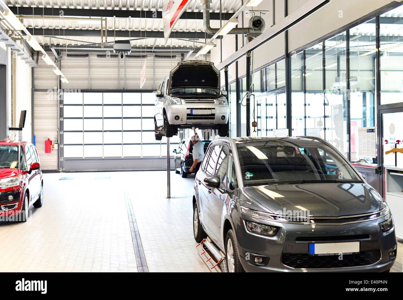 Vehicles in modern automotive workshop Stock Photo - Alamy