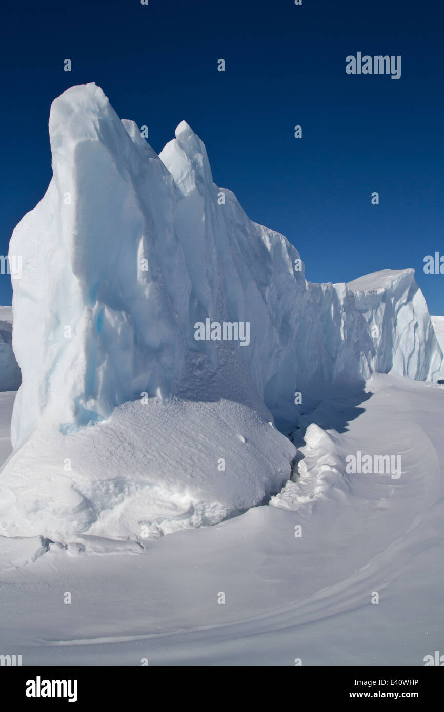 steep side of the dome of the iceberg that is frozen in Antarctic ...