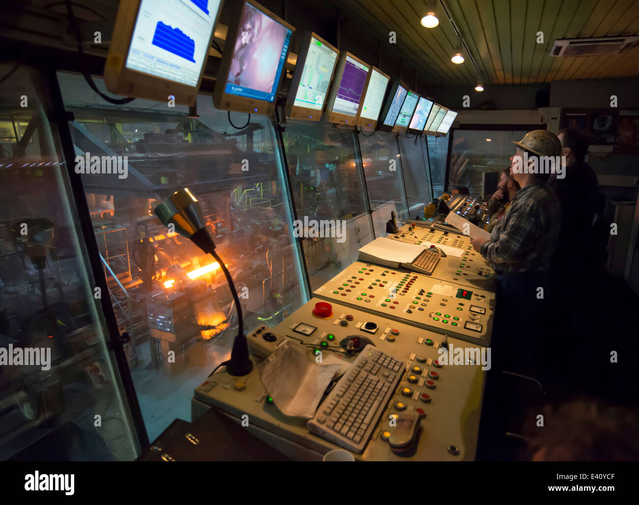 Technicians in control room of a tube rolling mill Stock Photo - Alamy