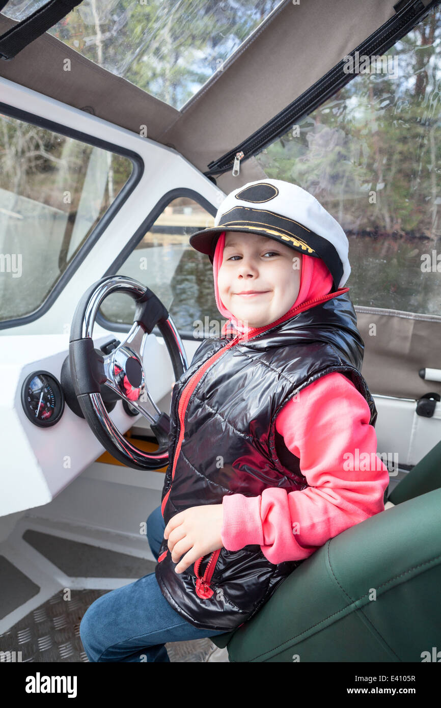 Happy smiling Caucasian girl driving motorboat as captain on deck Stock ...