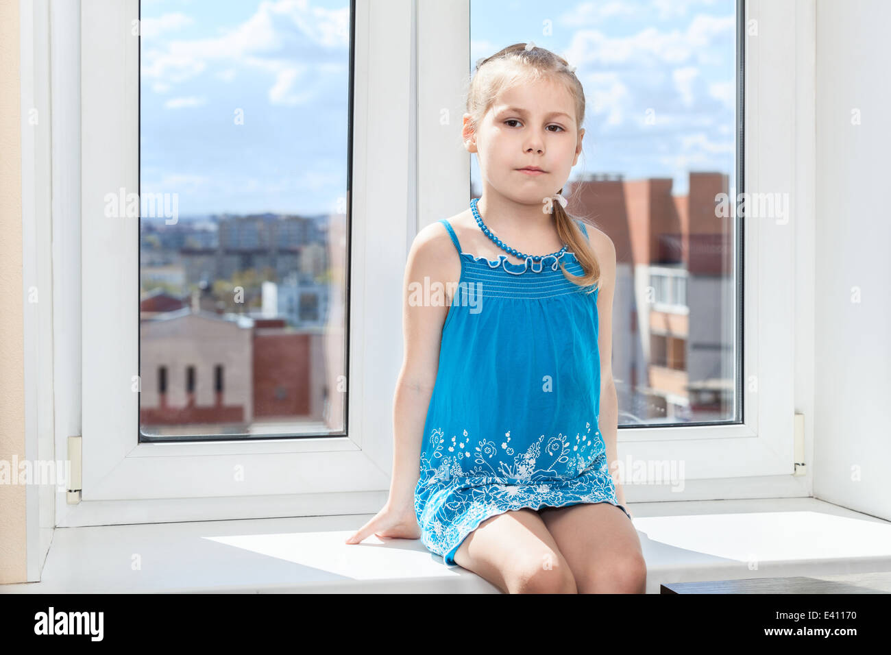 Little girl sitting window sill hi-res stock photography and images - Alamy