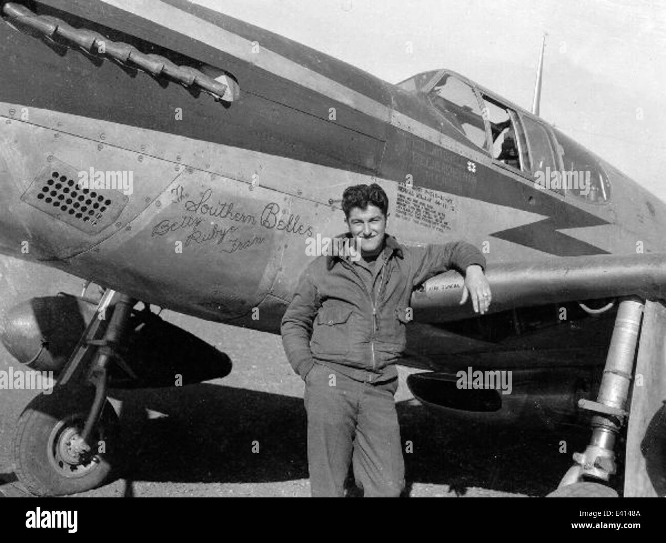 Lieutenant Dan Mitchell standing next to a P-51C Mustang aircraft, part ...