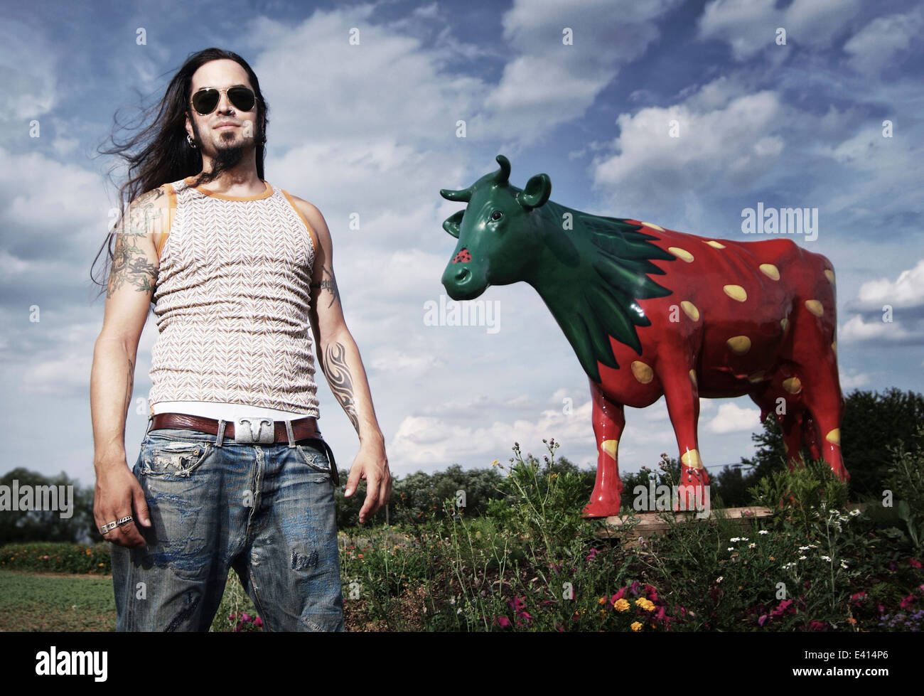 Portrait of a cool guy in front of a painted strawberry cow Stock Photo ...