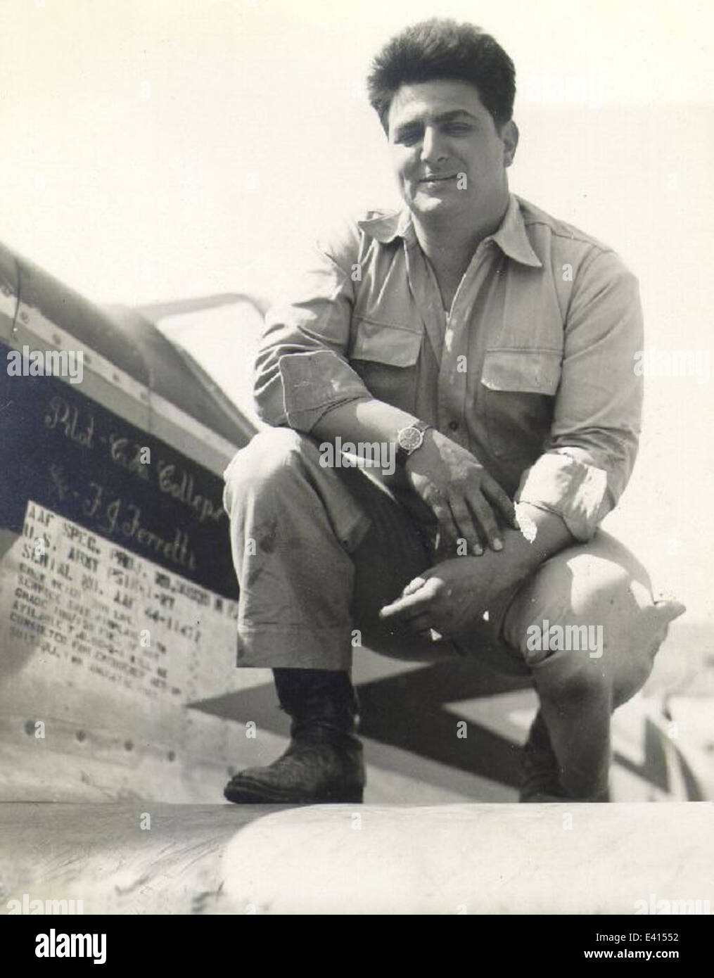 A photograph of SSgt Ferretti with a P-51C aircraft from the 118th ...