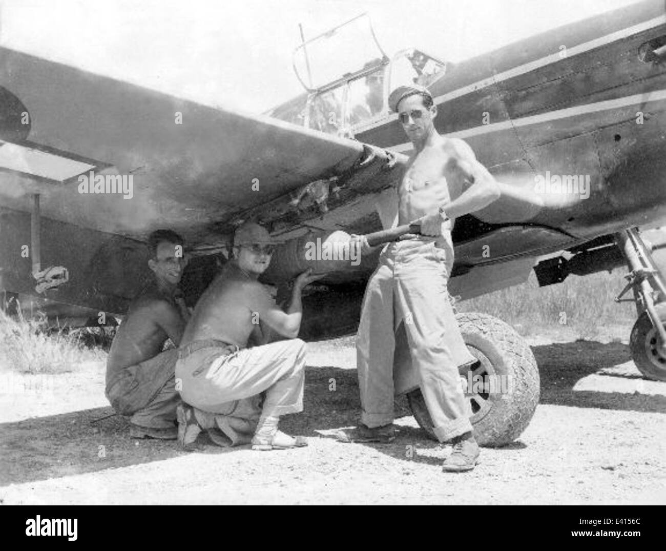 A photograph showing the loading of a 250-pound bomb onto a P-51C ...