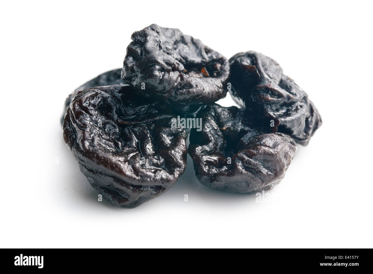 pitted prunes on white background Stock Photo - Alamy