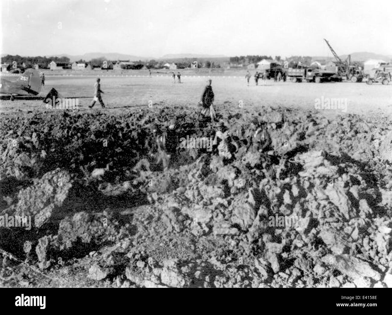 A photograph of a bomb-cratered airfield used by the 118th Tactical ...