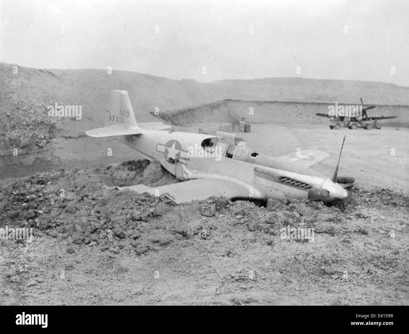 A photograph of the P-51B Mustang, showing Japanese bomb damage in ...