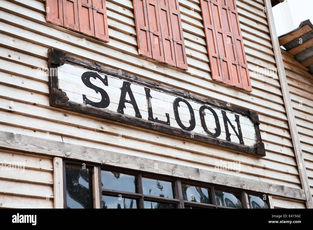 Saloon sign on building facade, nobody Stock Photo - Alamy