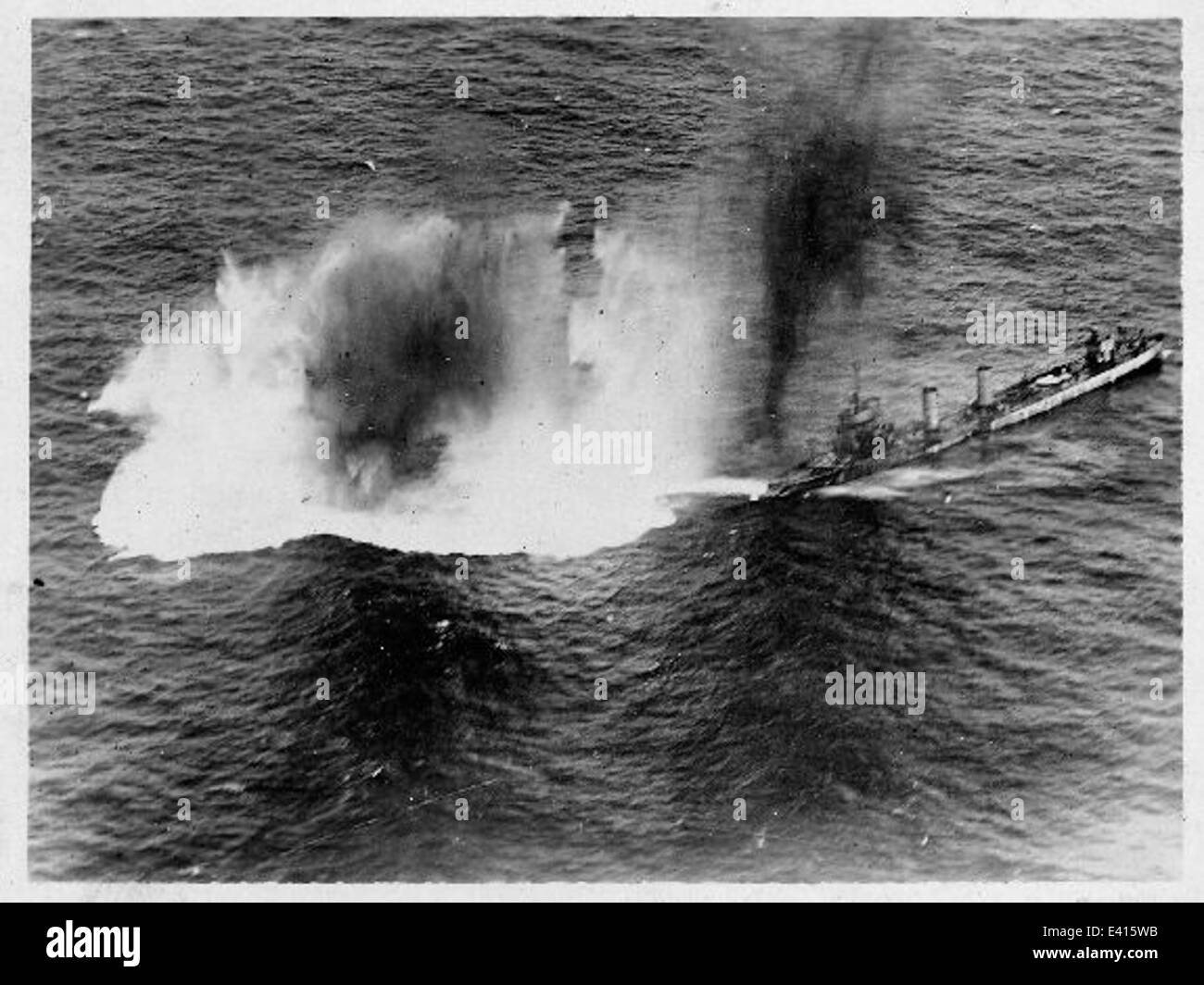 A dramatic photograph of an explosion aboard a warship, captured as ...