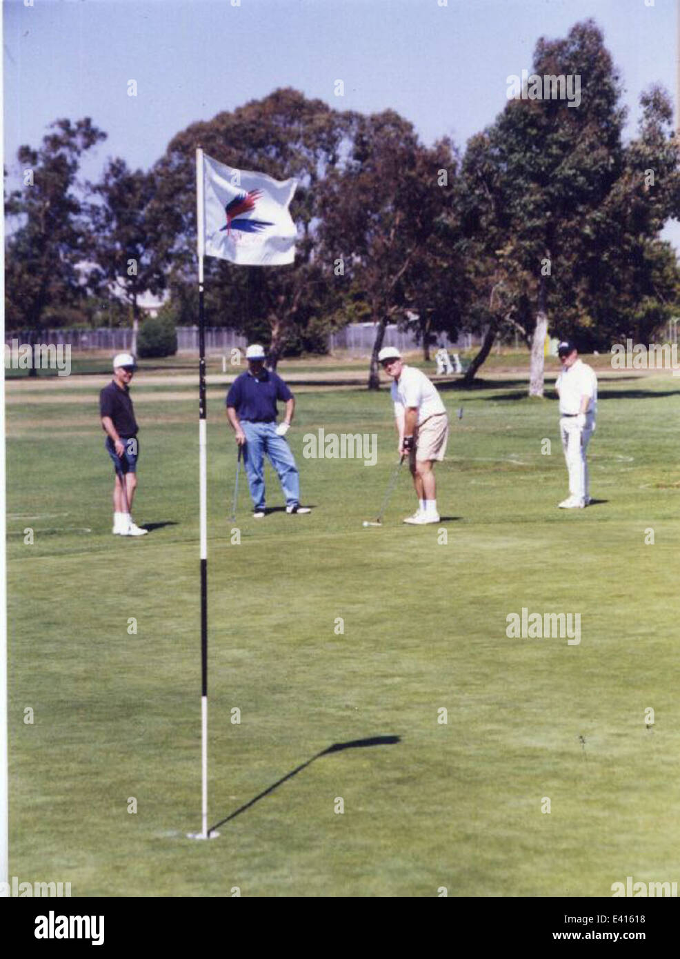 A photograph of President Bill Clinton playing golf, showcasing his ...