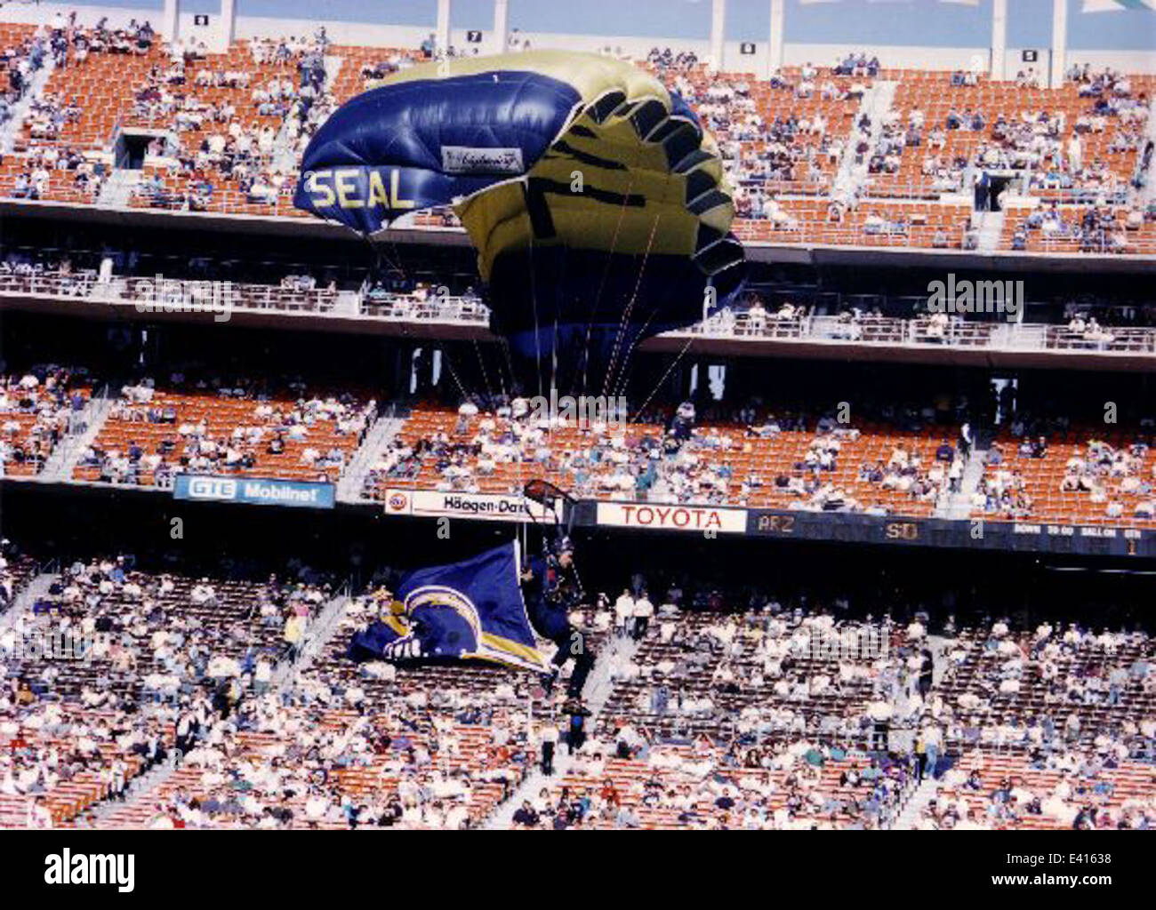 Photograph of a U.S. Navy SEAL parachuting into a stadium ...
