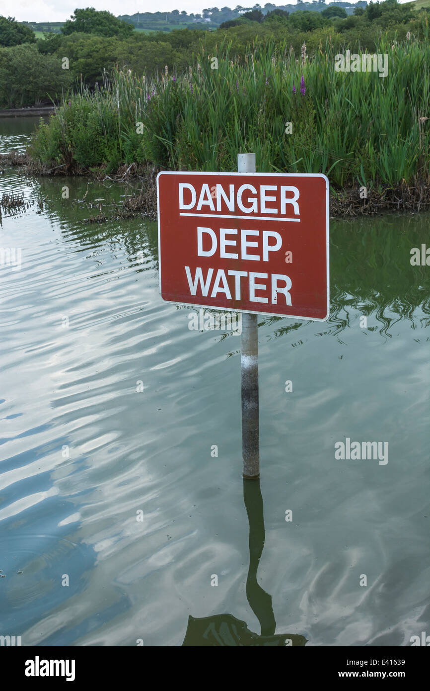 Danger warning sign for deep water. Visual metaphor for concept of ...