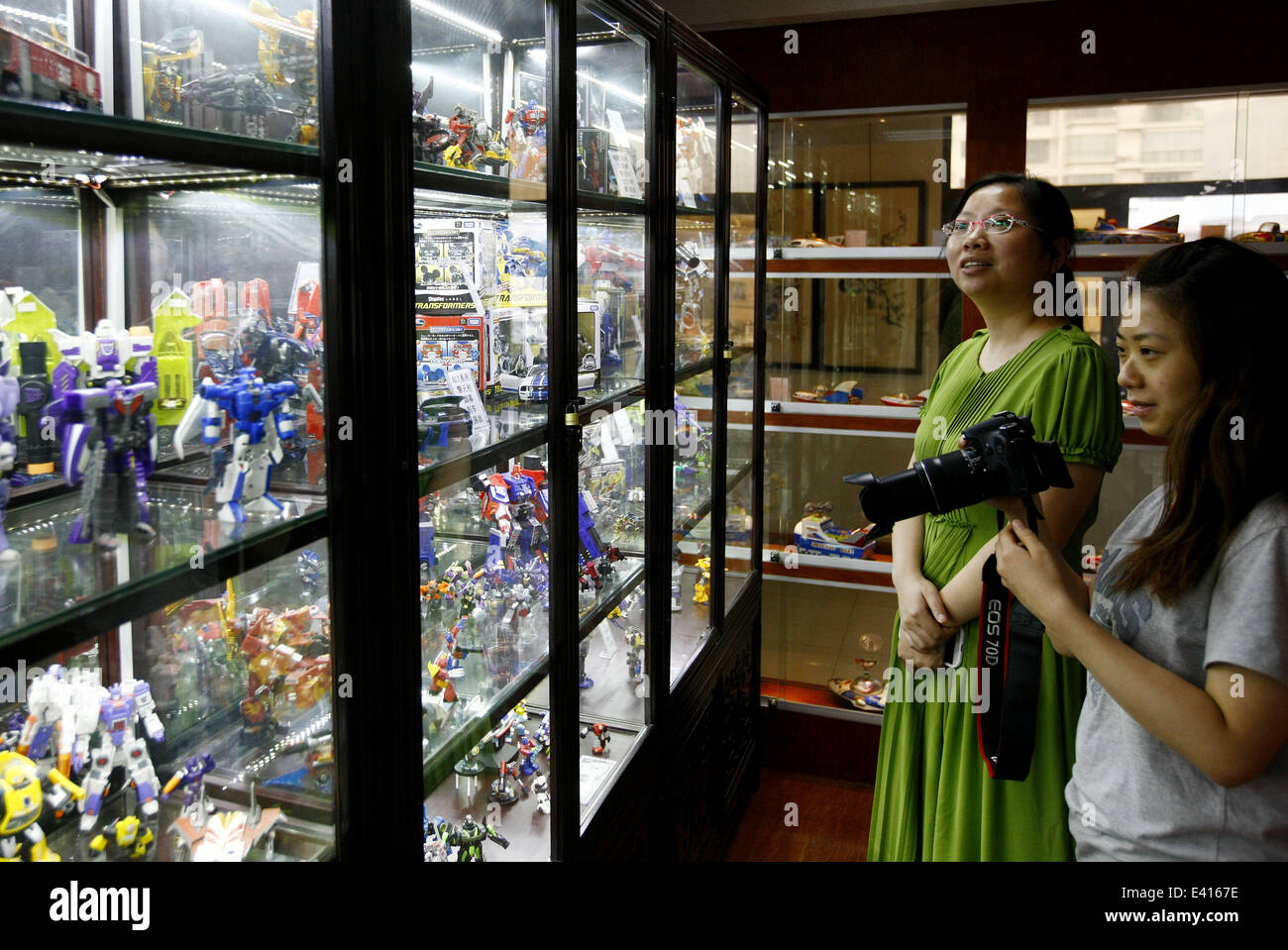 Shanghai. 2nd July, 2014. Visitors look at Transformer toys displayed ...